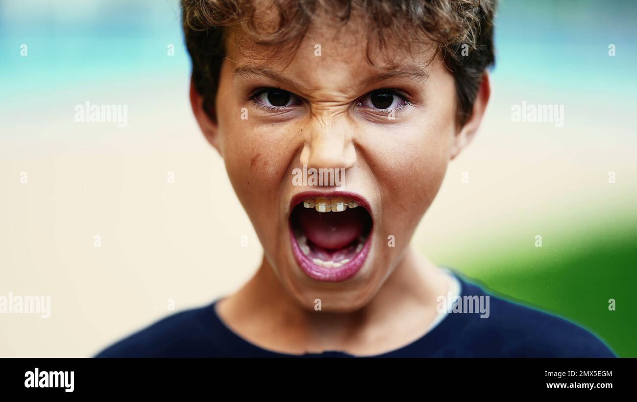 Angry small preteen boy looking at camera being furious. upset child ...