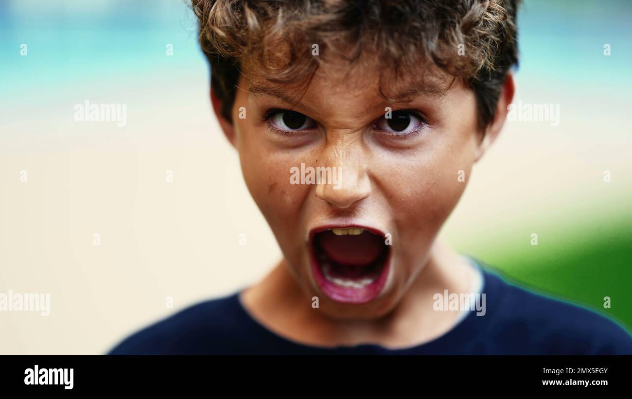Angry small preteen boy looking at camera being furious. upset child ...
