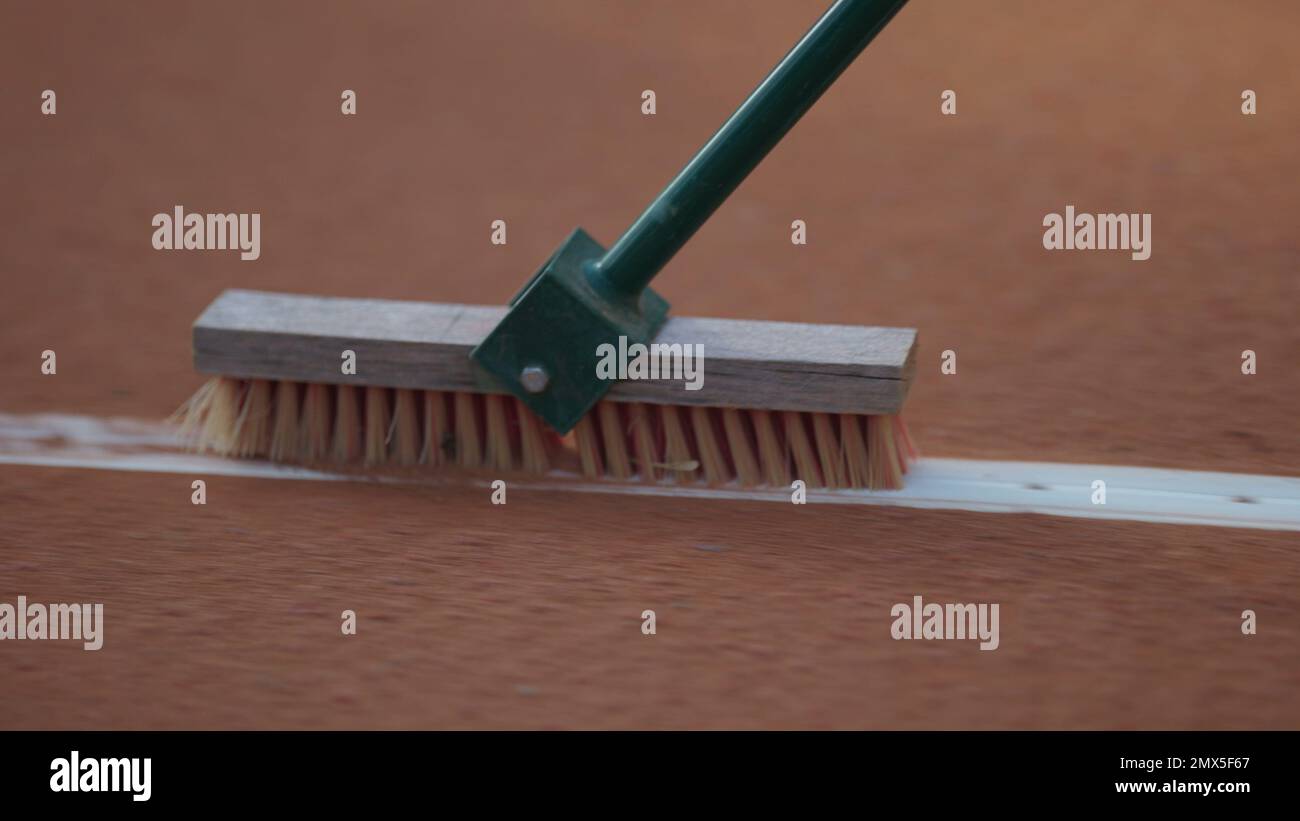 Cleaning marking line clay tennis court with brush. Clay tennis court ...