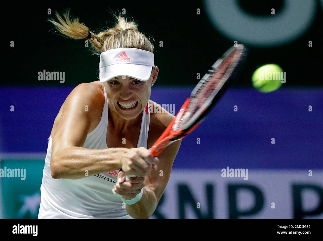 Angelique Kerber of Germany makes a backhand return to Dominika ...
