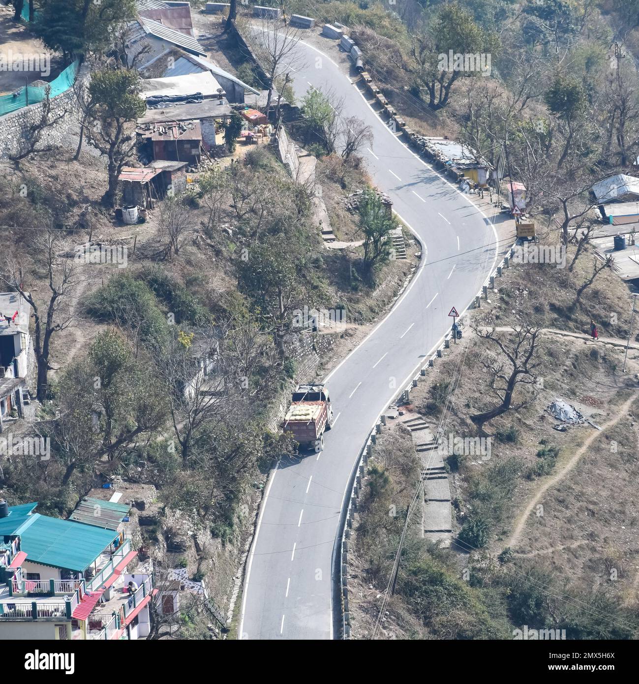 Aerial top view of traffic vehicles driving at mountains roads at ...