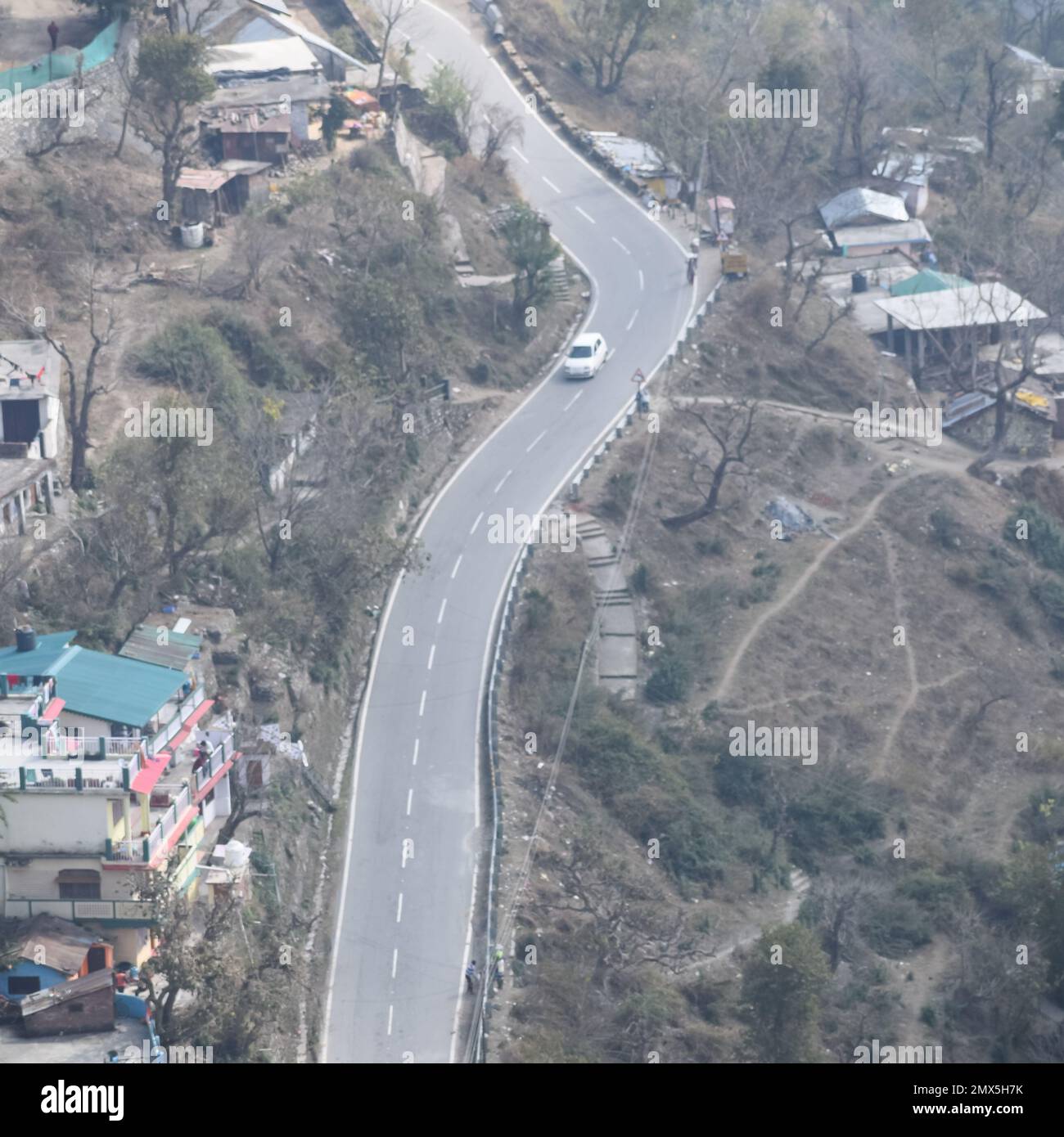 Aerial top view of traffic vehicles driving at mountains roads at ...