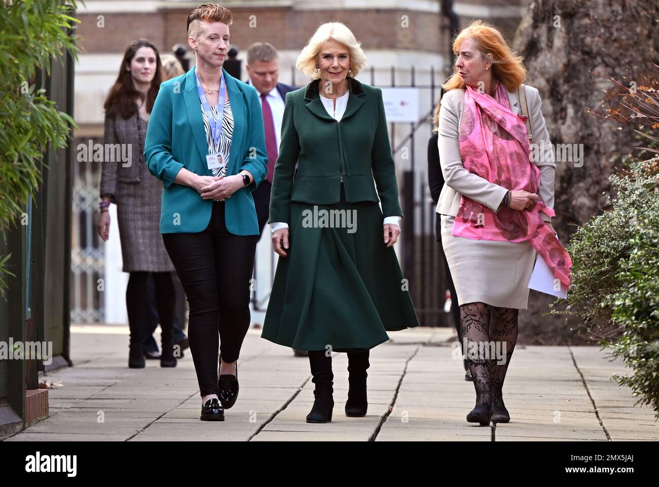 The Queen Consort (centre) talks to Coram CEO Carol Homden (right) and ...