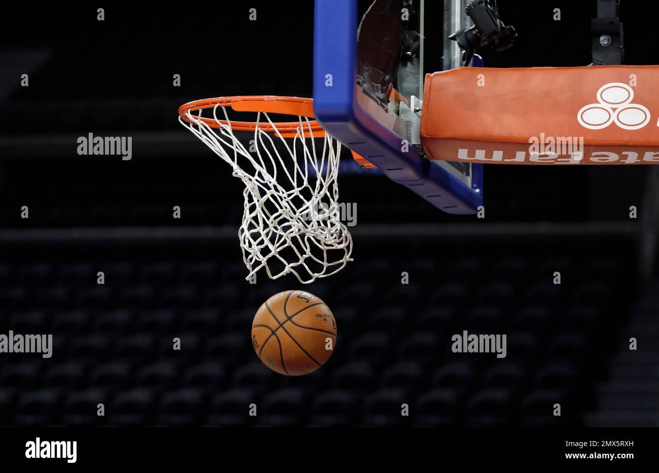 A basketball goes through the net during warmups before an NBA ...