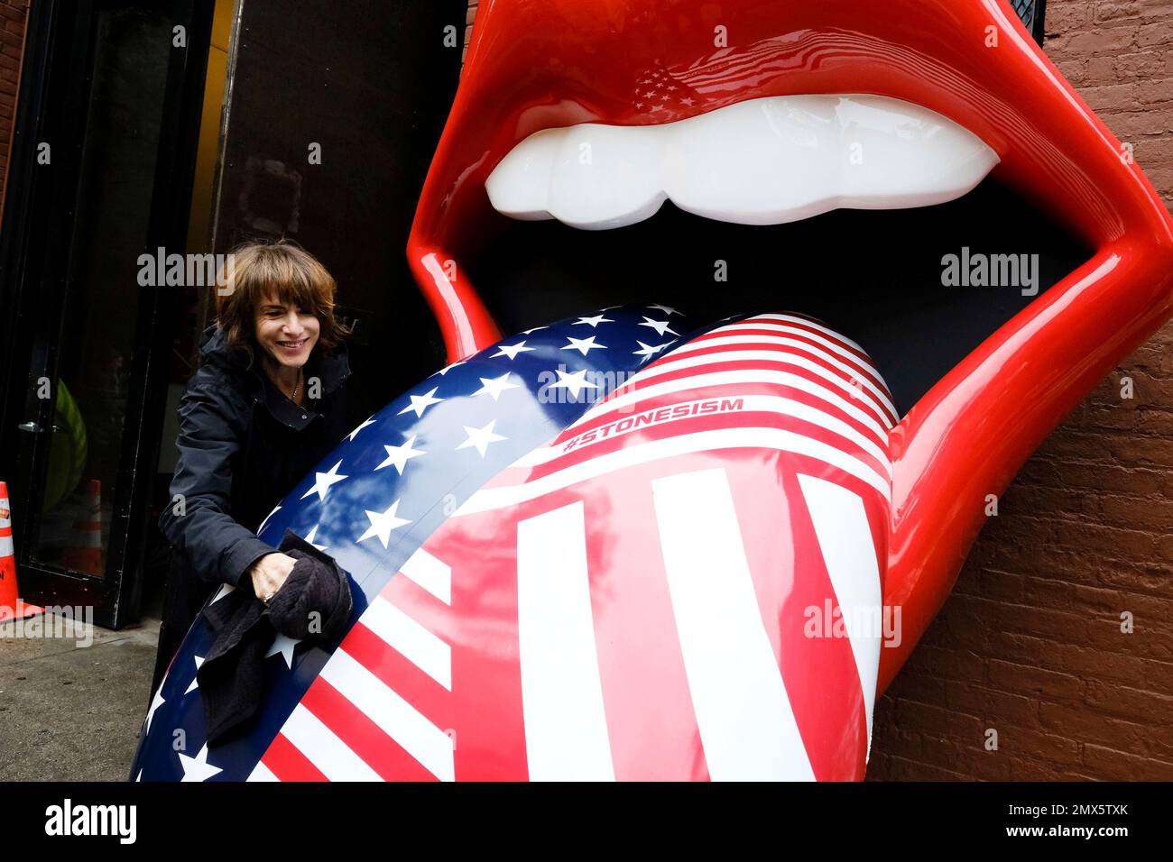 Curator Ileen Gallagher polishes a giant tongue during The Rolling ...