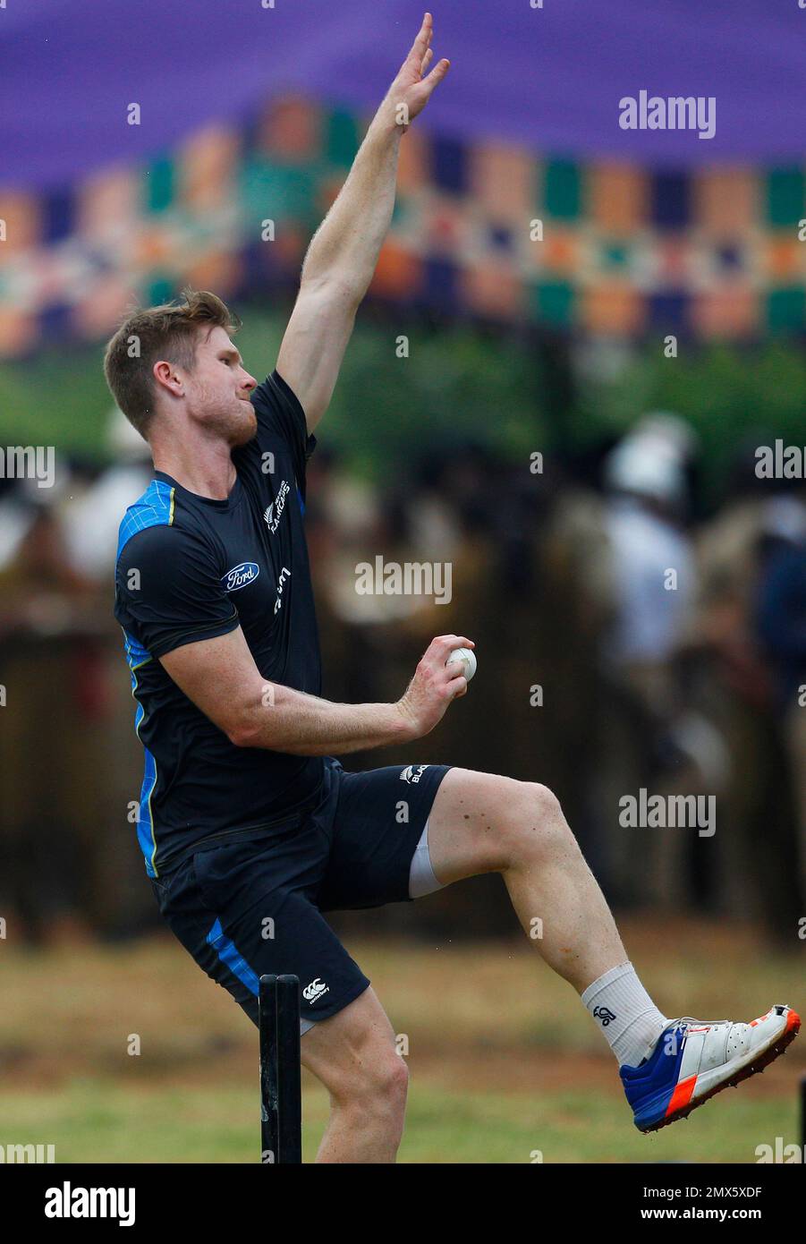 New Zealand's cricketer, James Neesham, bowls at the nets during a ...