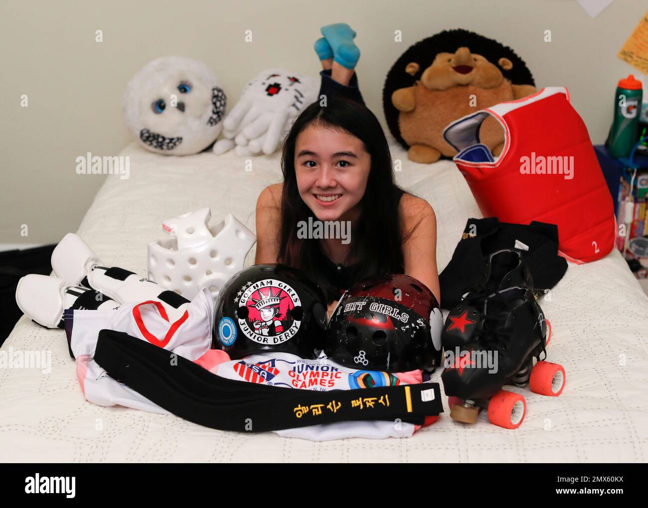 Alison Rogers poses for a photo with some of the jerseys and equipment ...
