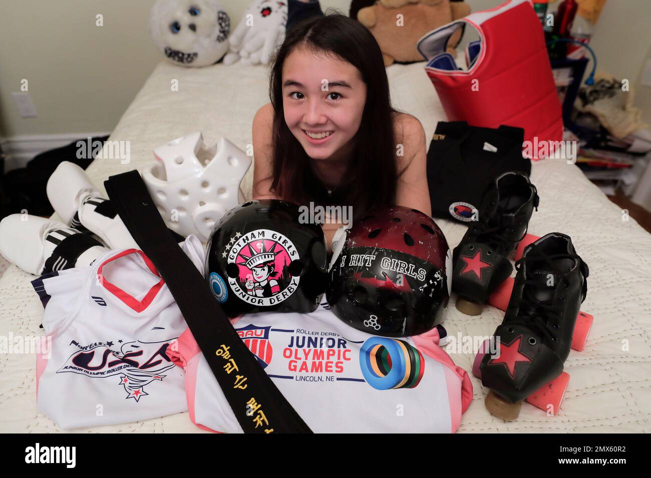 Alison Rogers poses for a photo with some of the jerseys and equipment ...