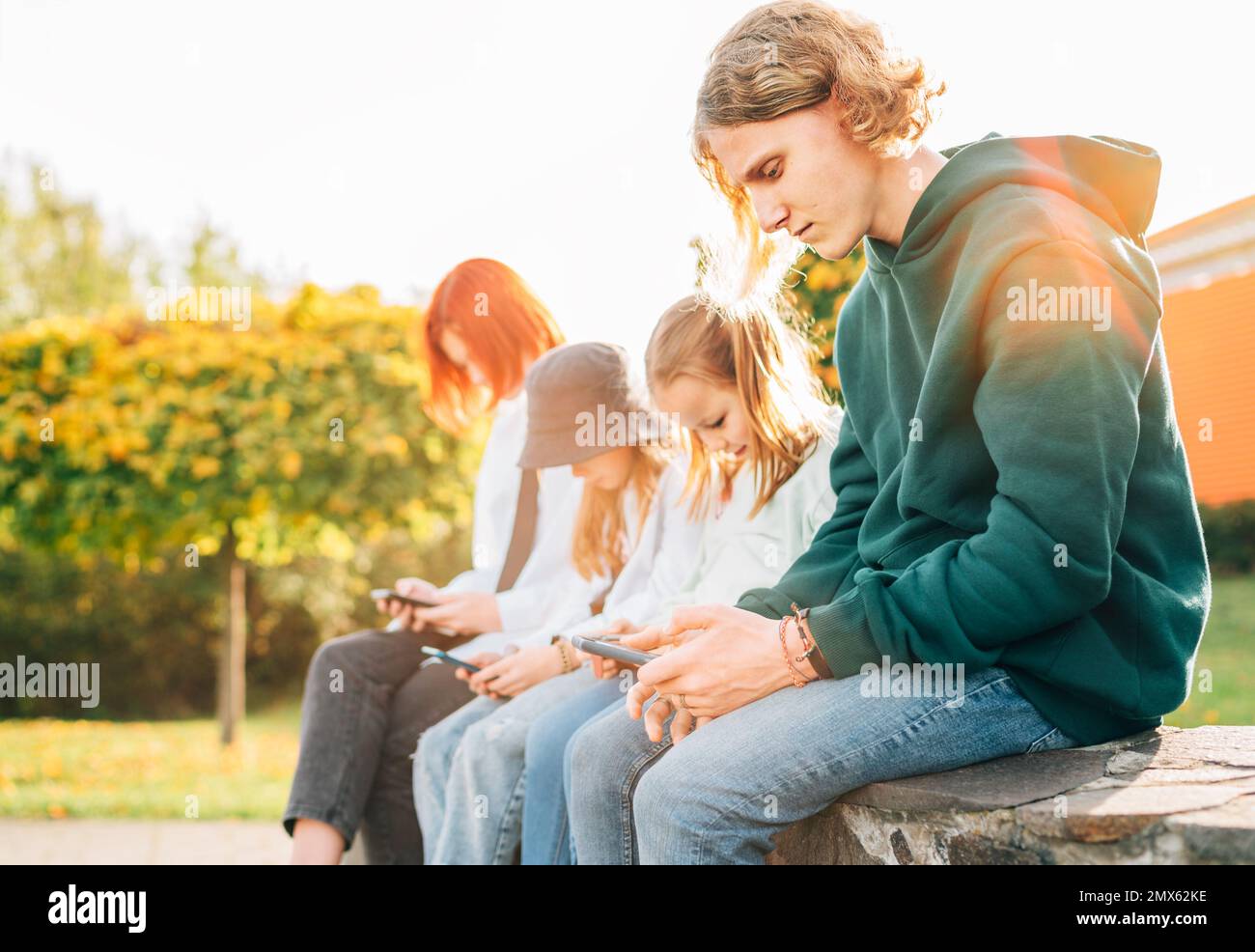Teenage boy and a sister girls kids sitting and cindly browsing their ...