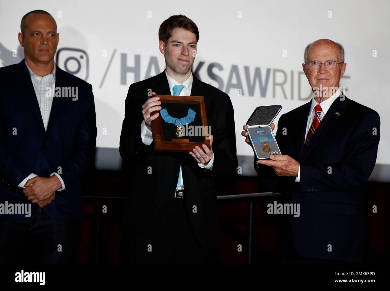Actor Vince Vaughn looks on as Charles Googe, center, and Dr. Charles Knapp, right, show two ...