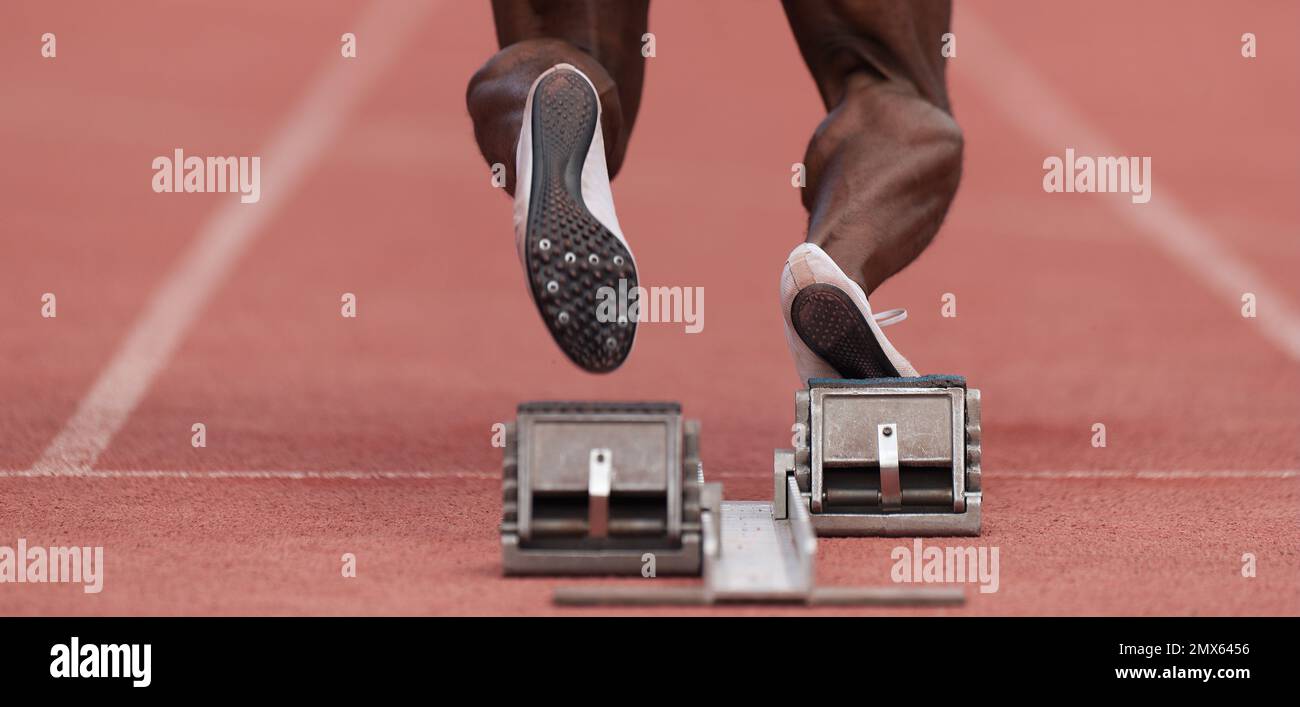 Athlete male feet on starting block ready for a sprint start Stock ...