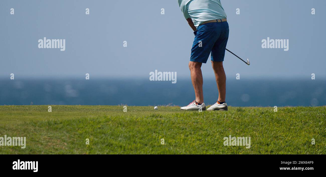 Golfer hitting ball with force. The grass distribution the blur of golf ...