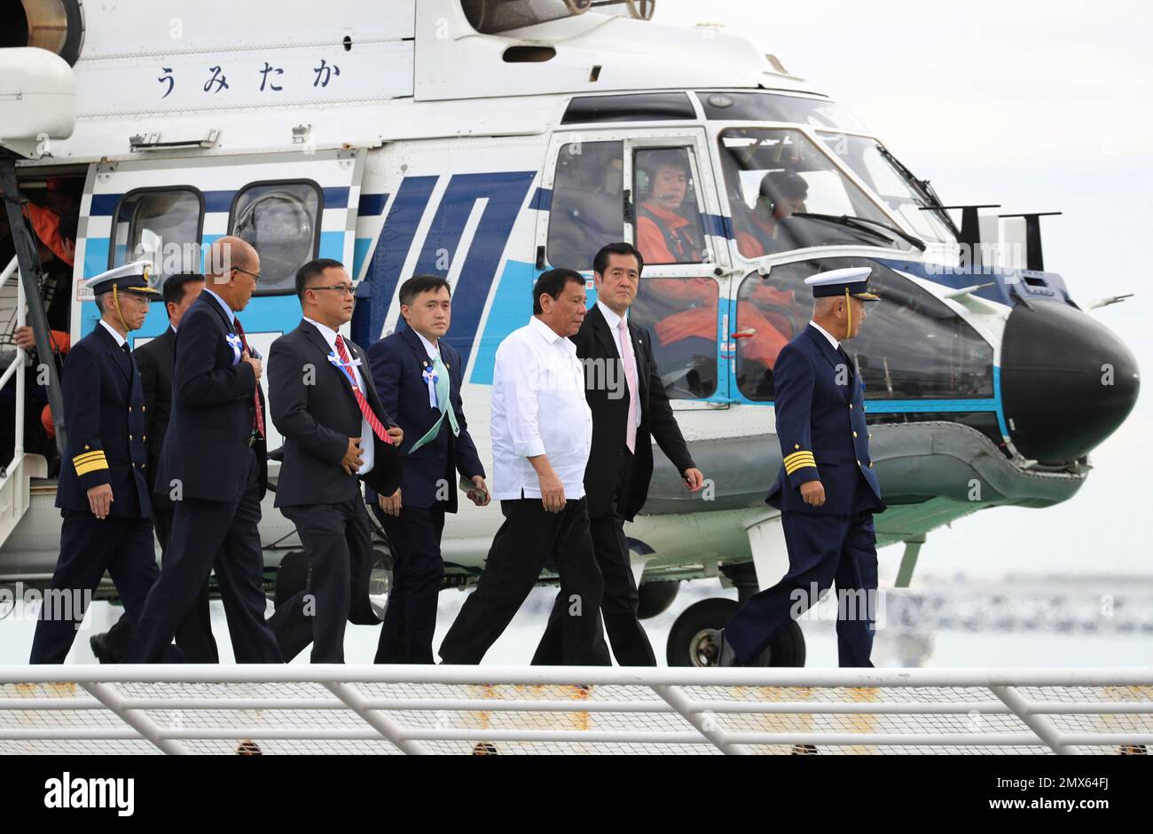 Philippine President Rodrigo Duterte, center in white outfit, is ...