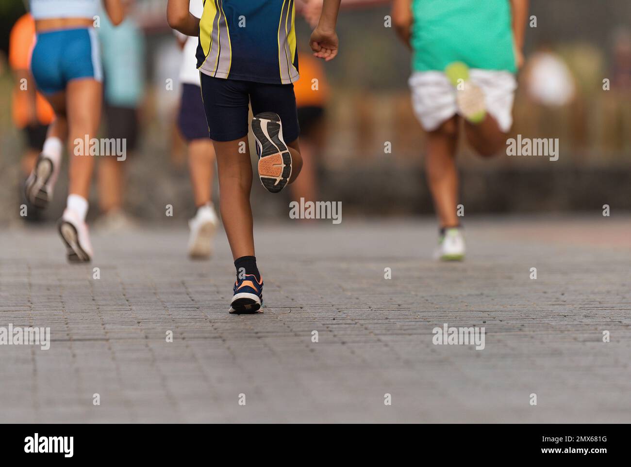 Running children, young athletes run in a kids run race,running on city ...