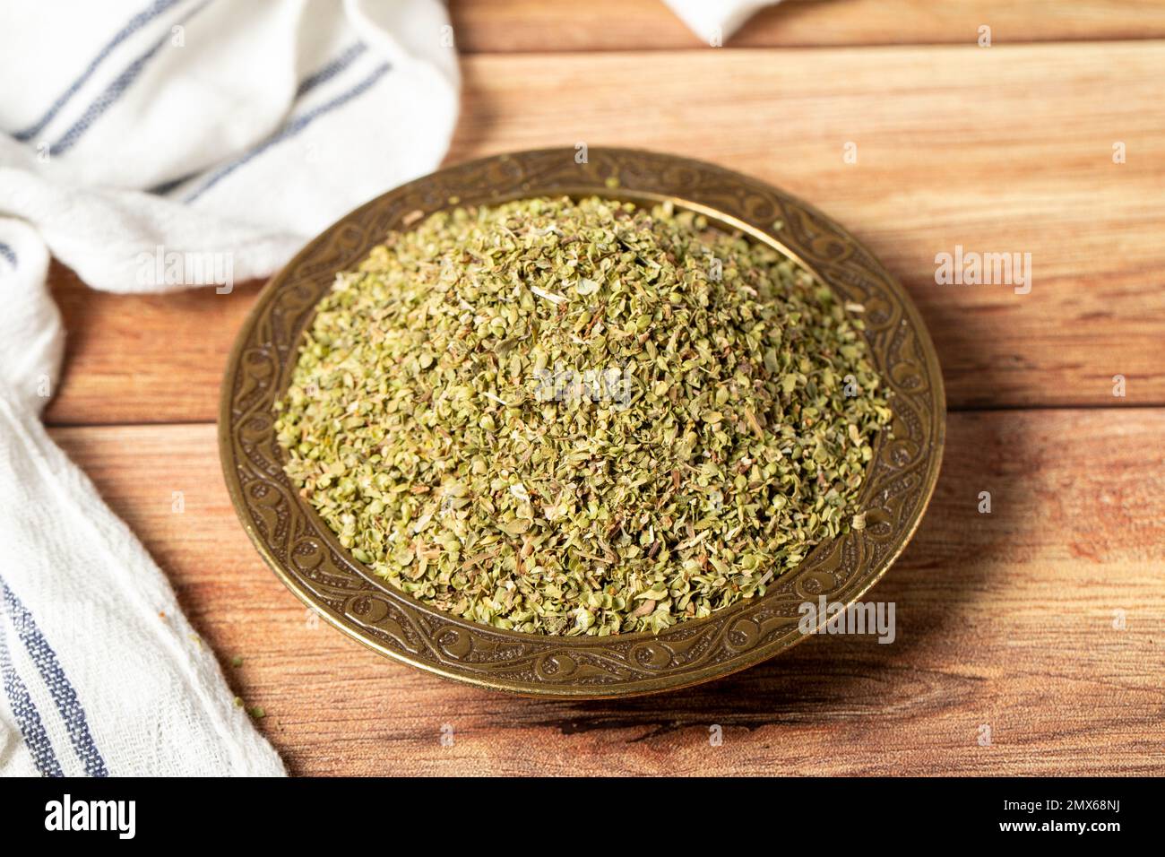 Dried thyme leaves. Thyme spice in a bowl on a wooden background. Dry ...