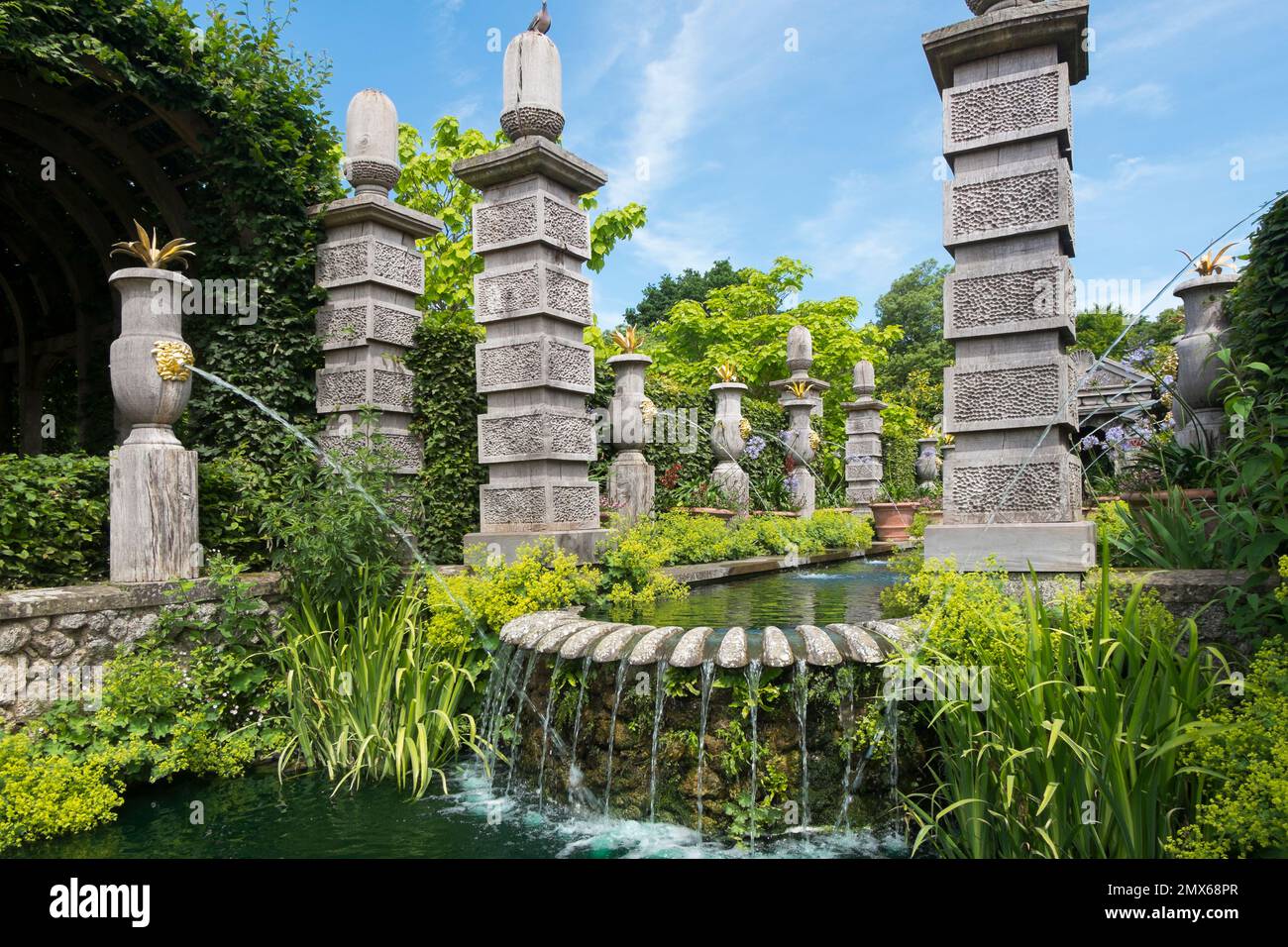 A pool with Alchemilla Mollis and a shell grotto pavillionand water ...