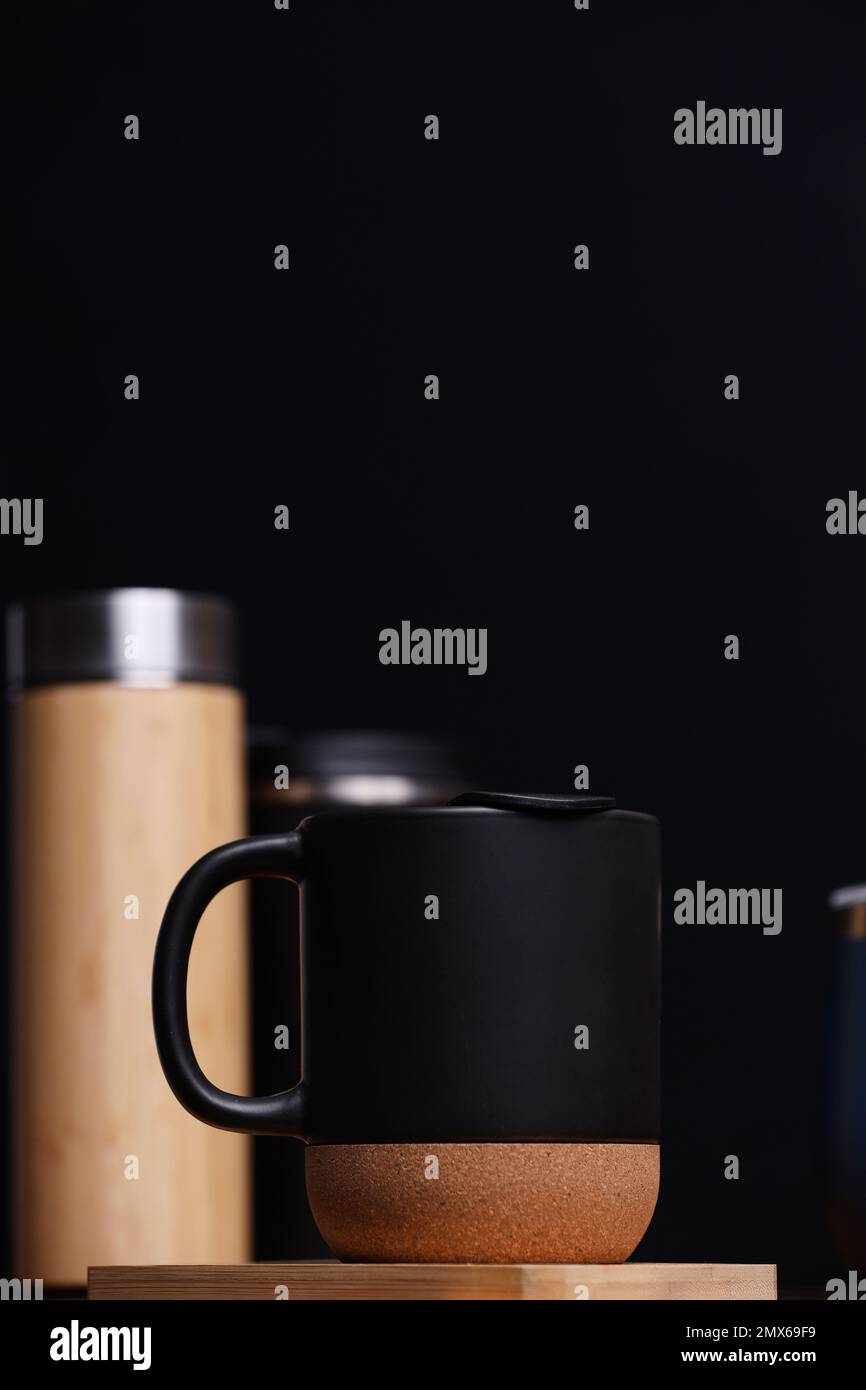 Black color coffee mug in mug with wooden bottom Stock Photo - Alamy