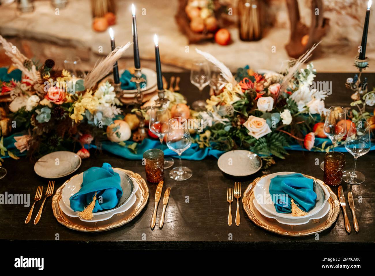 Exquisite, elegant golden and blue table set decoration in moody dark ...