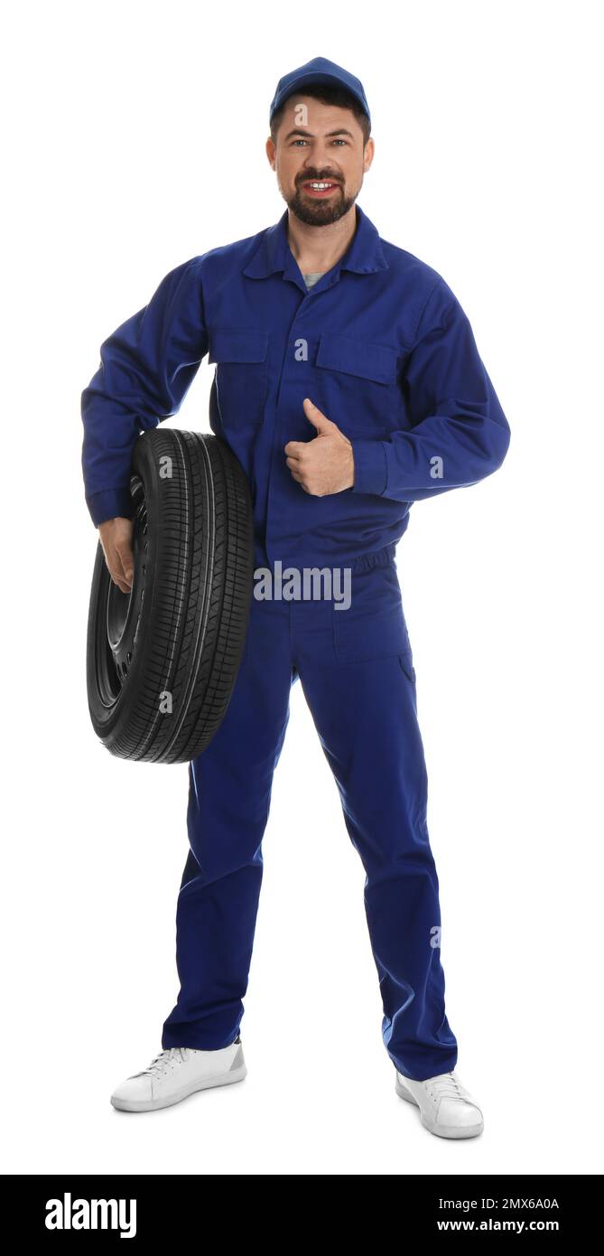 Full length portrait of professional auto mechanic with wheel on white ...