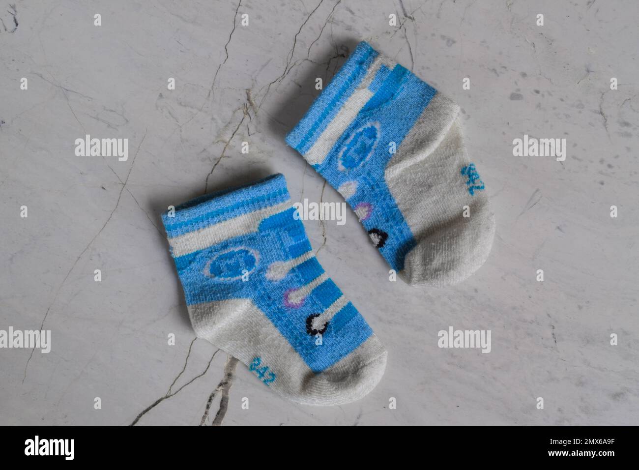 Pair of small baby socks on ceramic background. Blue baby socks Stock ...