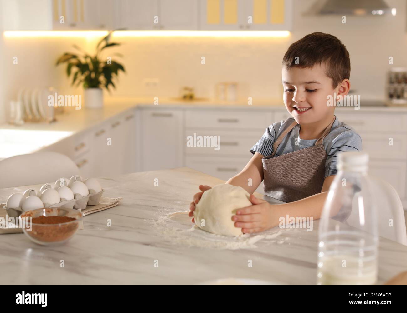 Cute little boy with dough at table in kitchen. Cooking pastry Stock ...