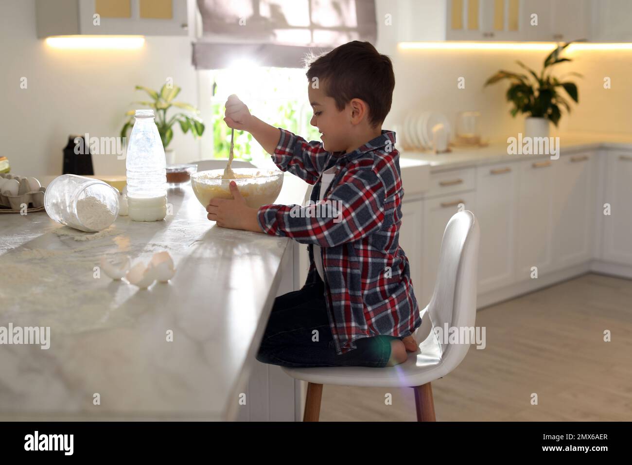 Cute little boy cooking dough in kitchen at home Stock Photo - Alamy