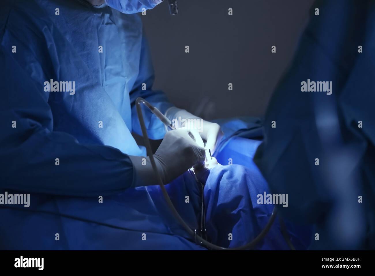 Professional doctor performing operation in surgery room, closeup Stock ...