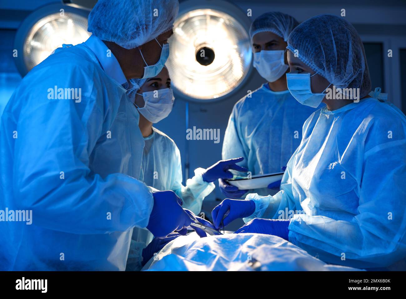 Team of professional doctors performing operation in surgery room Stock ...