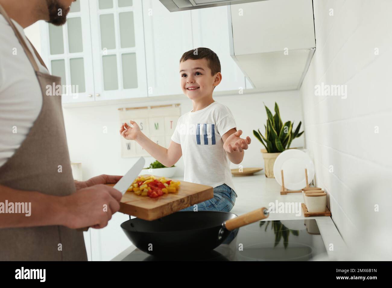 Father and son cooking together in kitchen, closeup Stock Photo - Alamy
