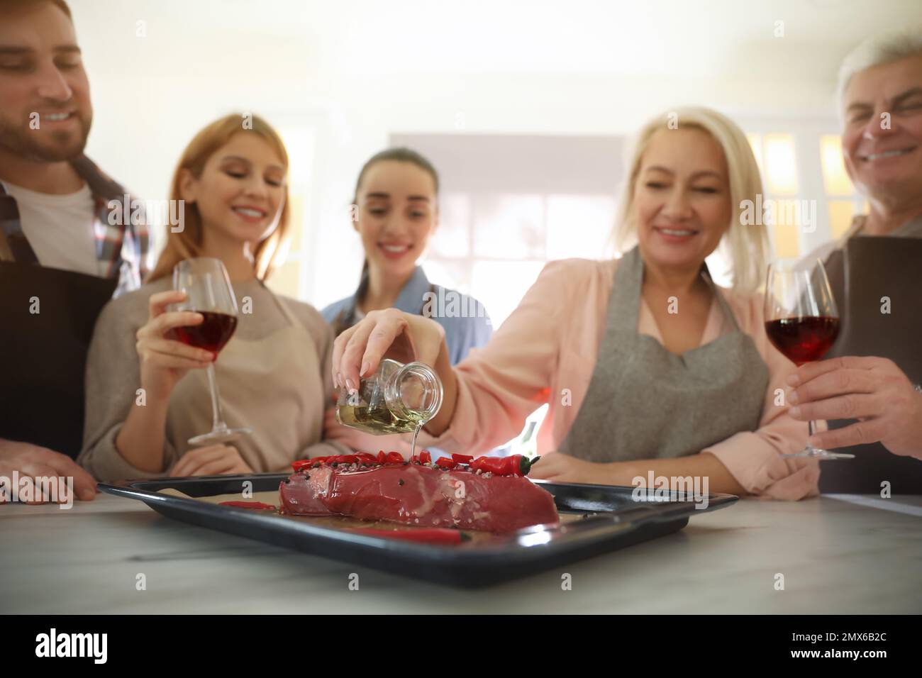 Happy people cooking food together in kitchen Stock Photo - Alamy