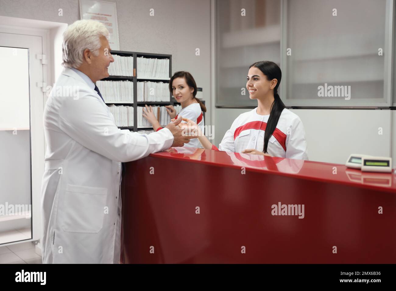 Reception of modern surgery clinic with working staff Stock Photo - Alamy