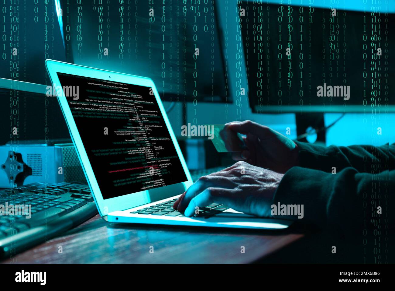 Cyber Criminal With Credit Card Hacking System At Table Digital Binary Code On Background Stock