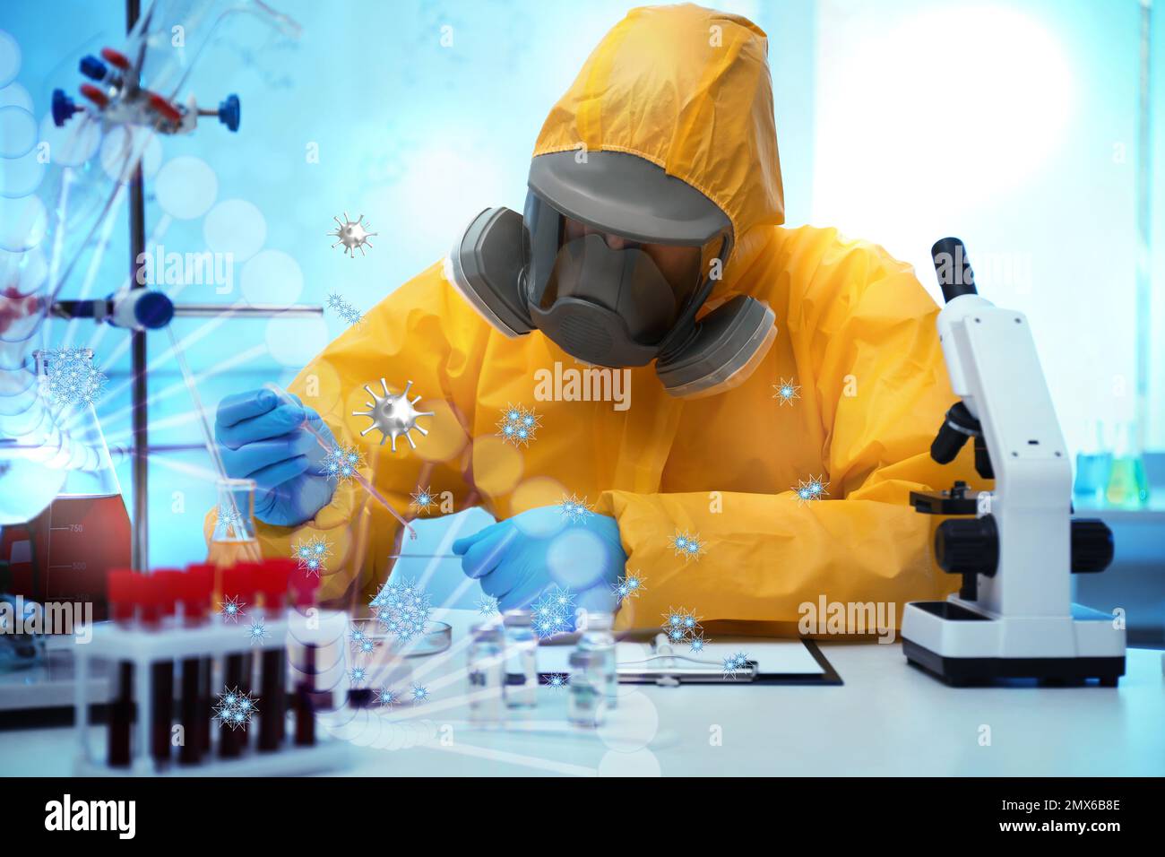 Scientist in chemical protective suit dripping reagent on microscope ...