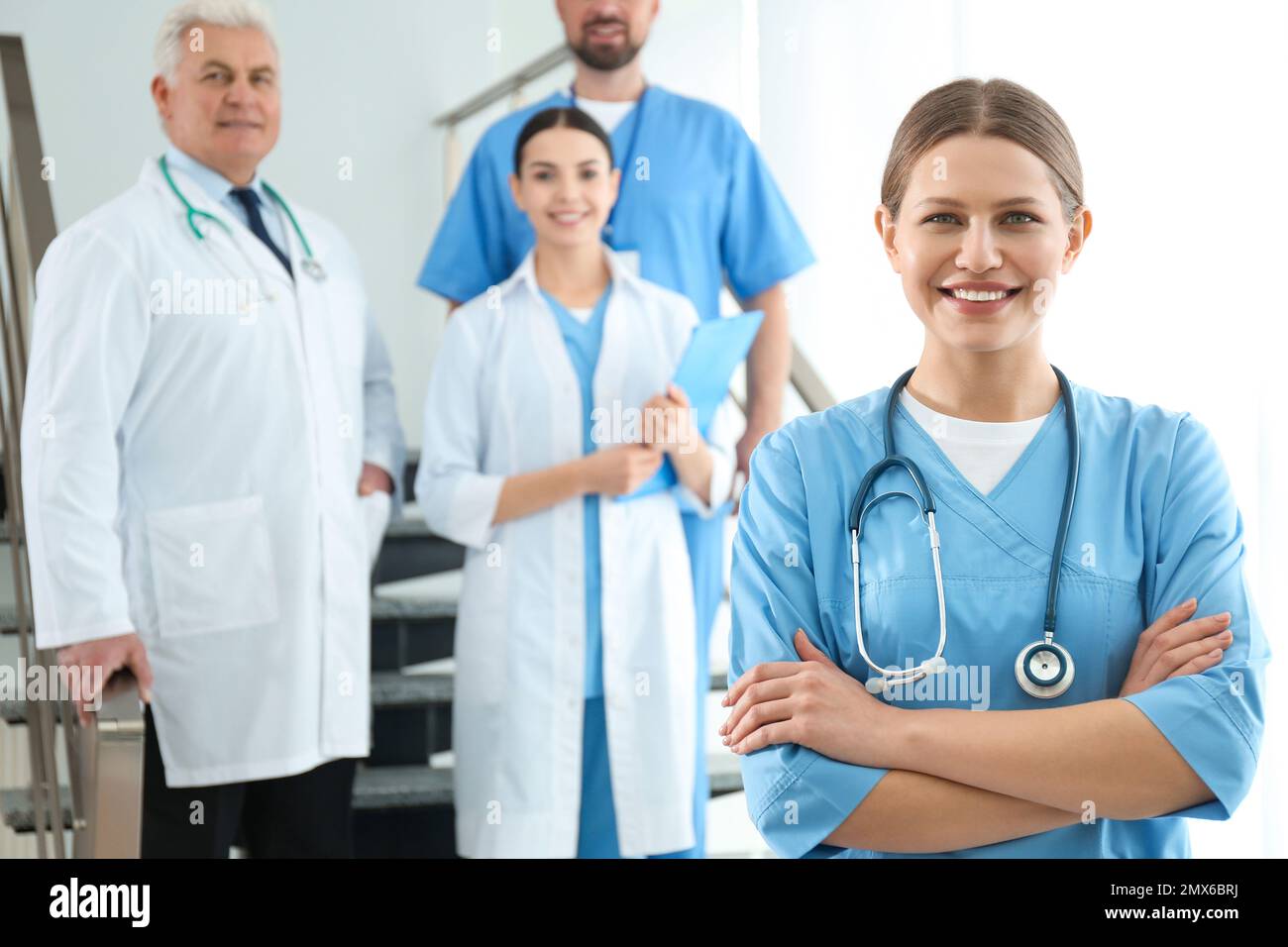 Young doctor and colleagues in hospital. Medical service Stock Photo ...