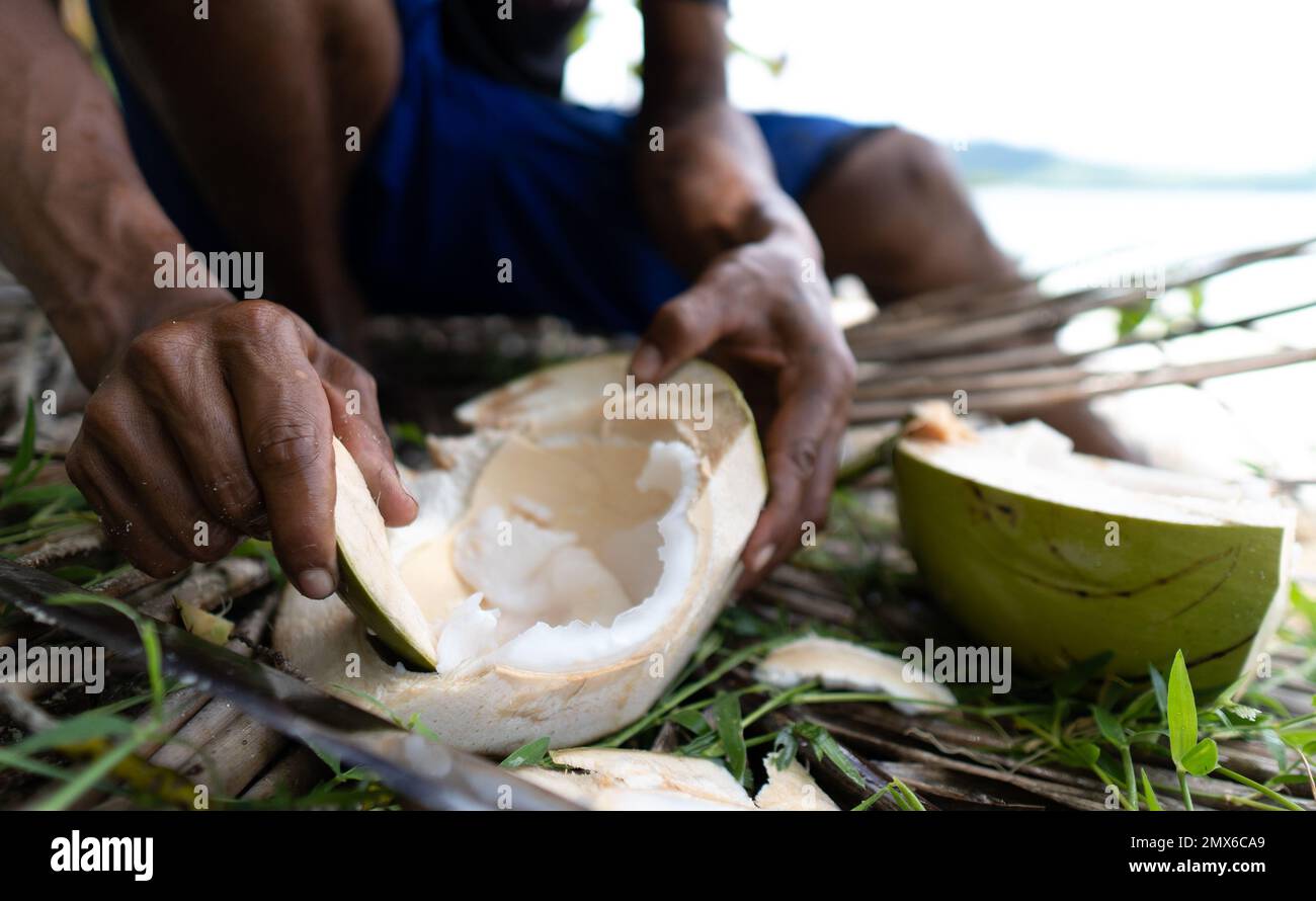 closeup detail of the hands of a young Filipino fisherman eating ...