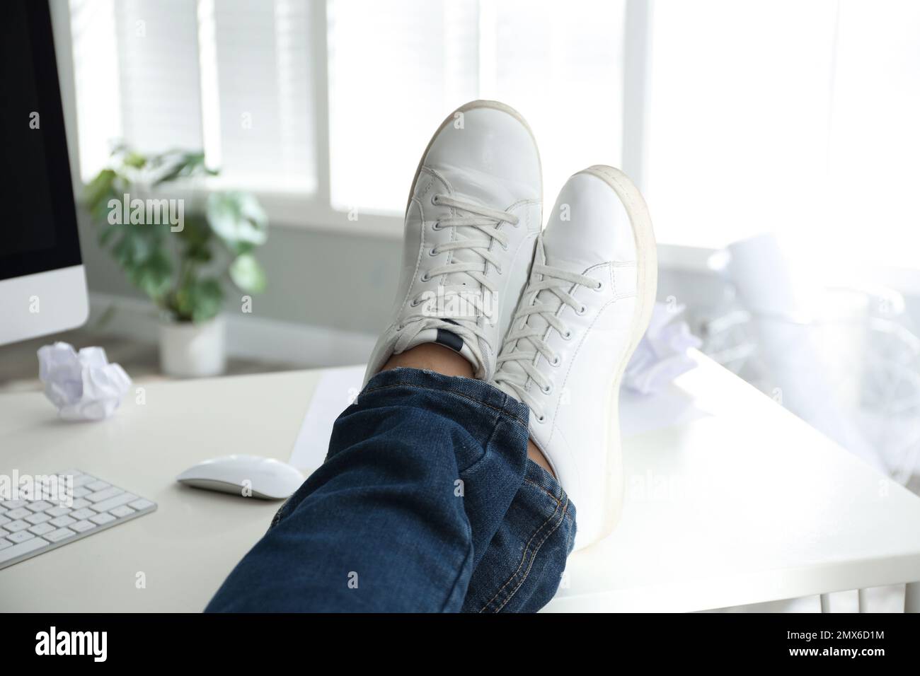 Lazy office employee resting with feet on desk in office, closeup Stock ...