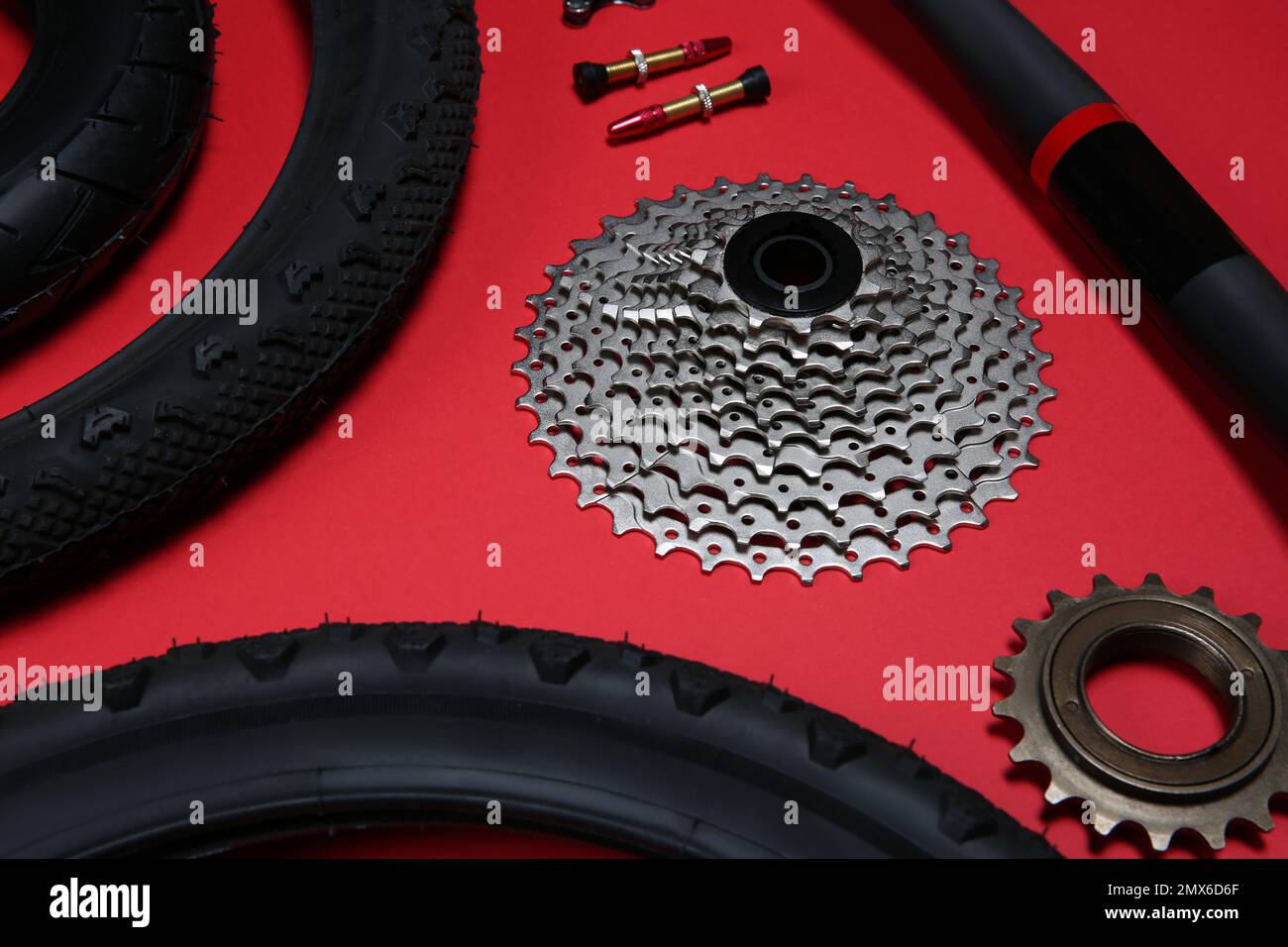 Set of different bicycle tools and parts on red background, closeup ...