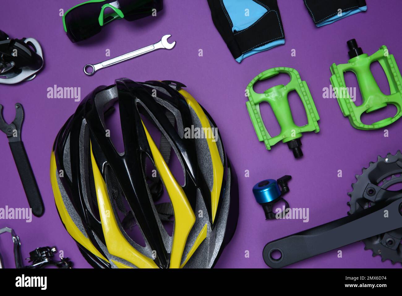 Set of different bicycle tools, accessories and parts on purple ...
