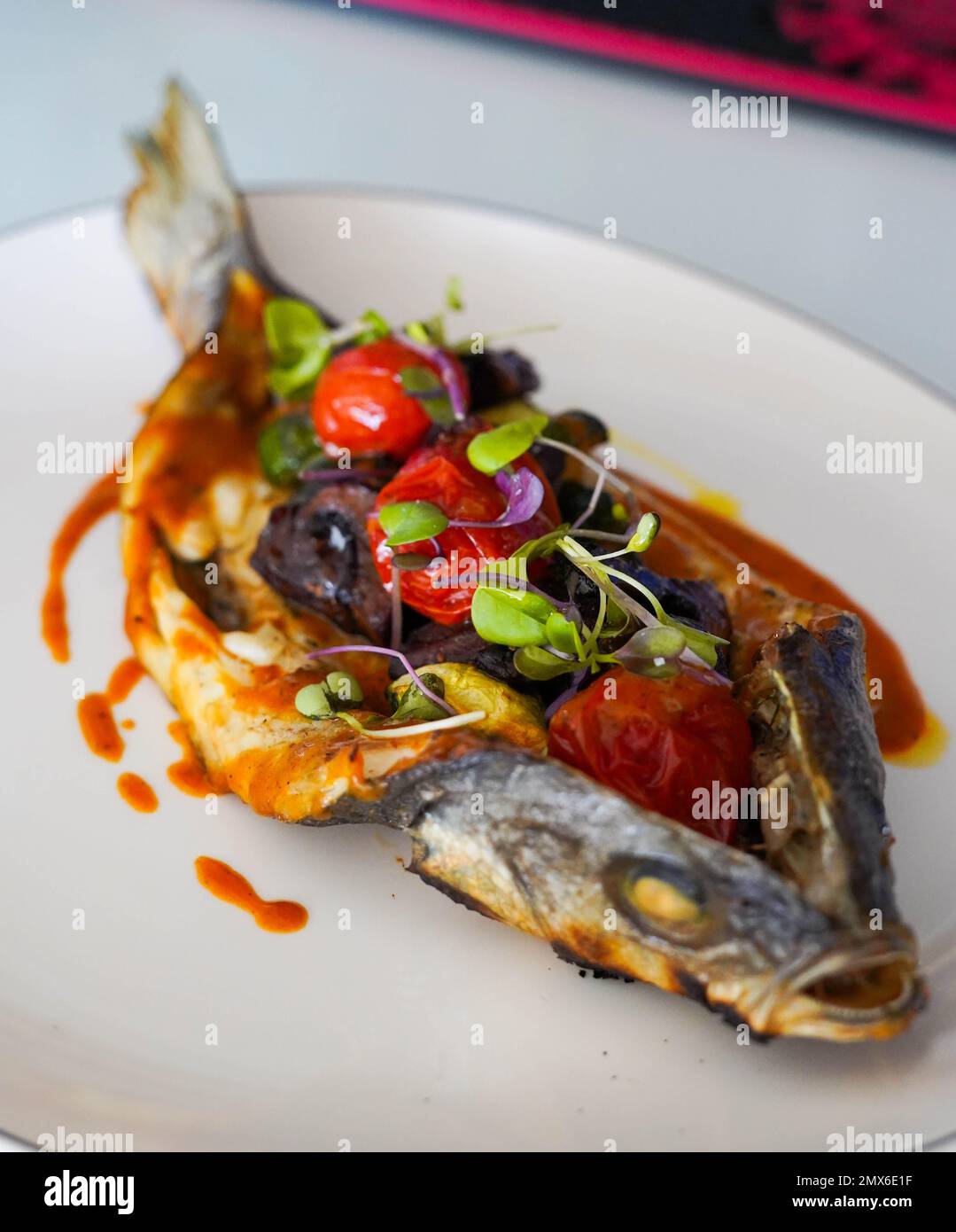 Dish of baked bream with vegetables in a gourmet restaurant Stock Photo ...
