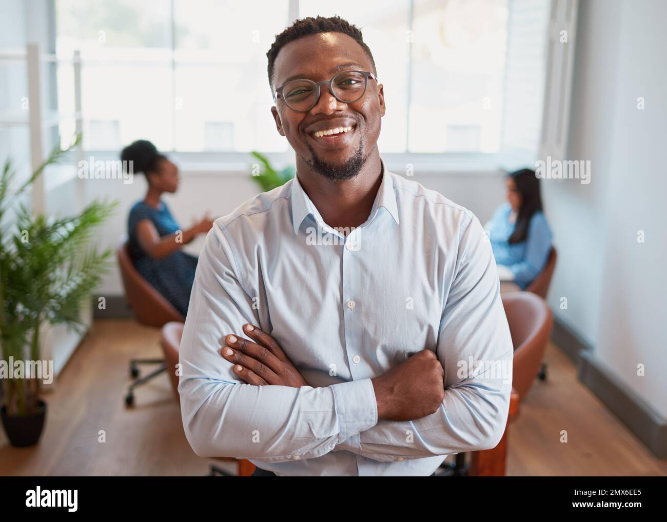 Portrait of happy Black businessman, CEO, manager folding arms with ...
