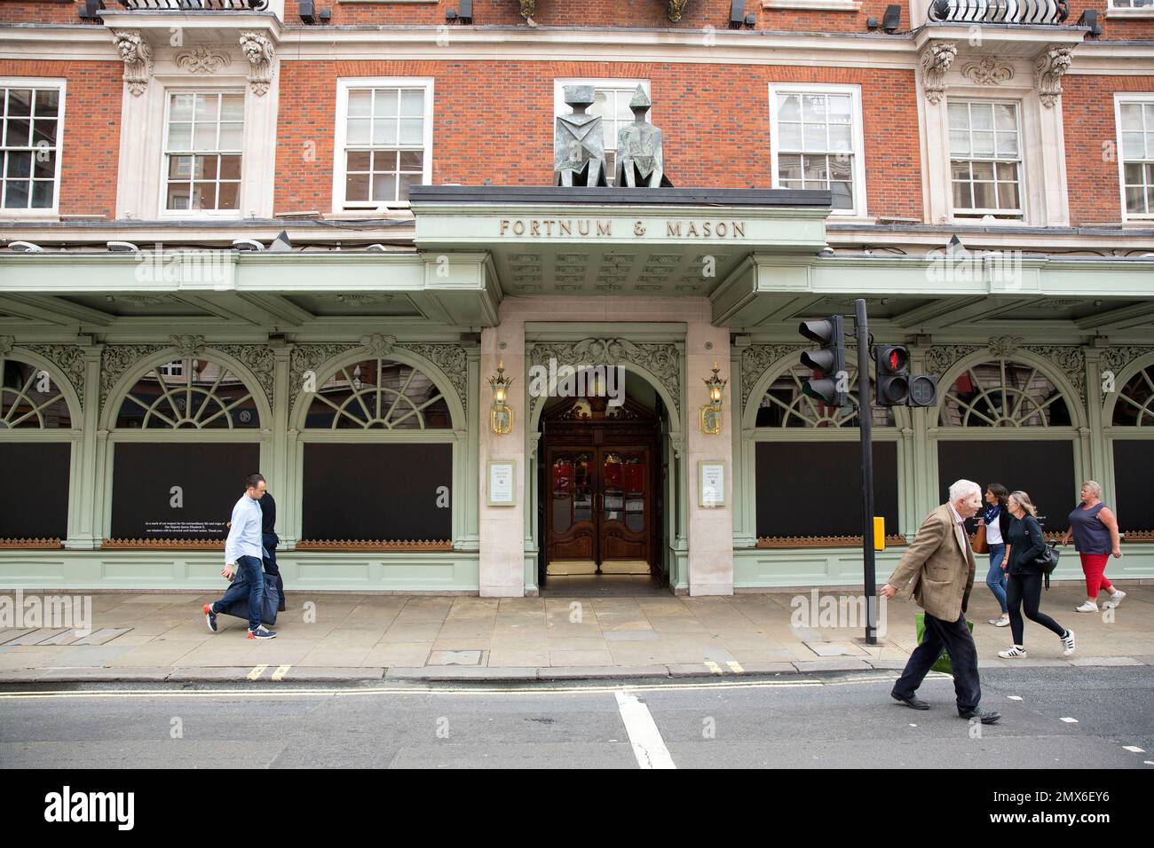 Shop windows are seen covered as a mask of their respect outside a ...