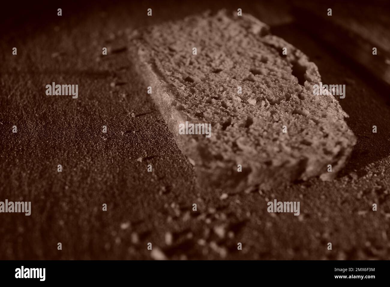 Detail of a slice of fresh home made baked bread (in monochrome Sepia ...