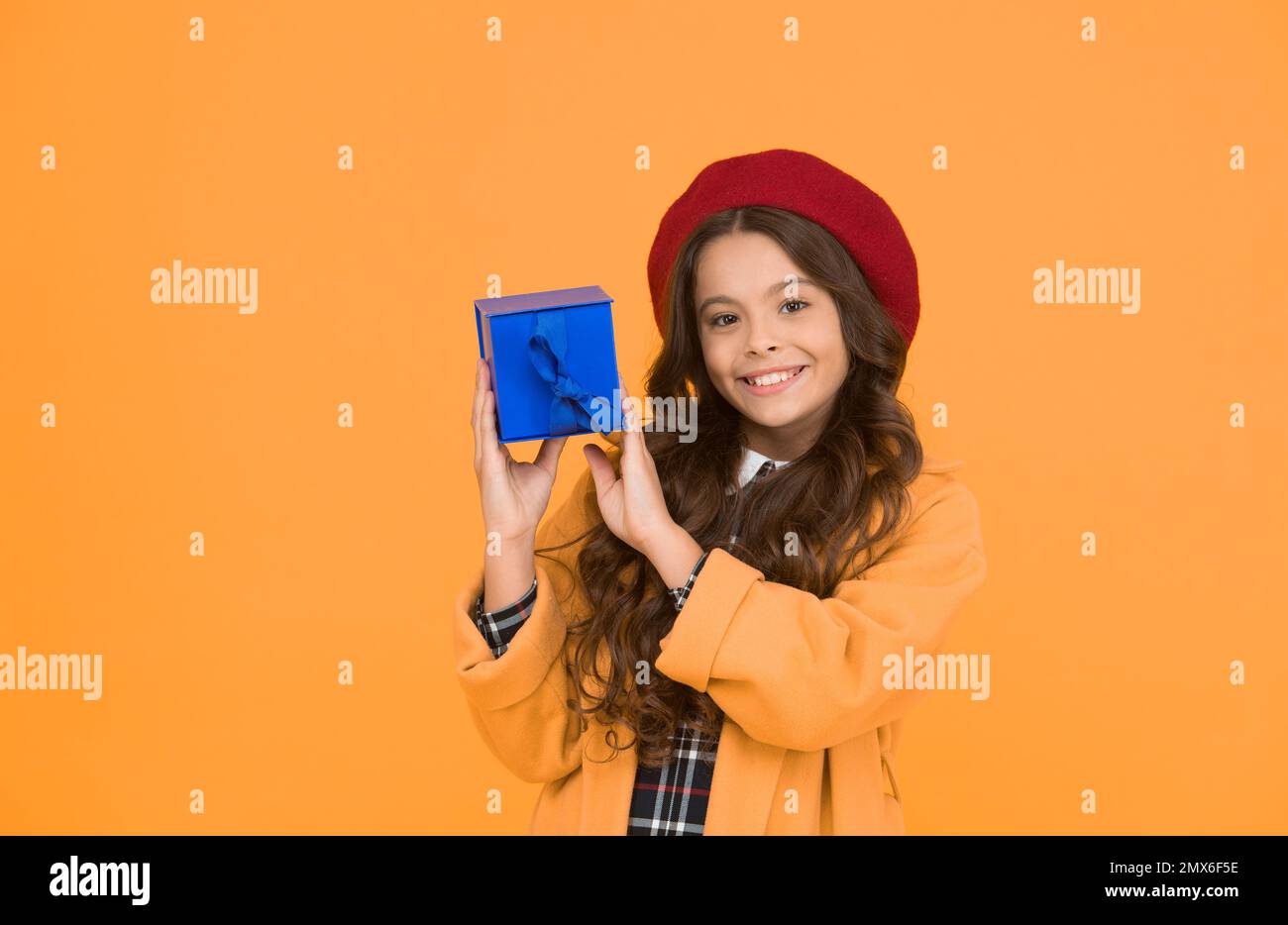 Surprise and pleasant present box. Smiling child hold gift box ...