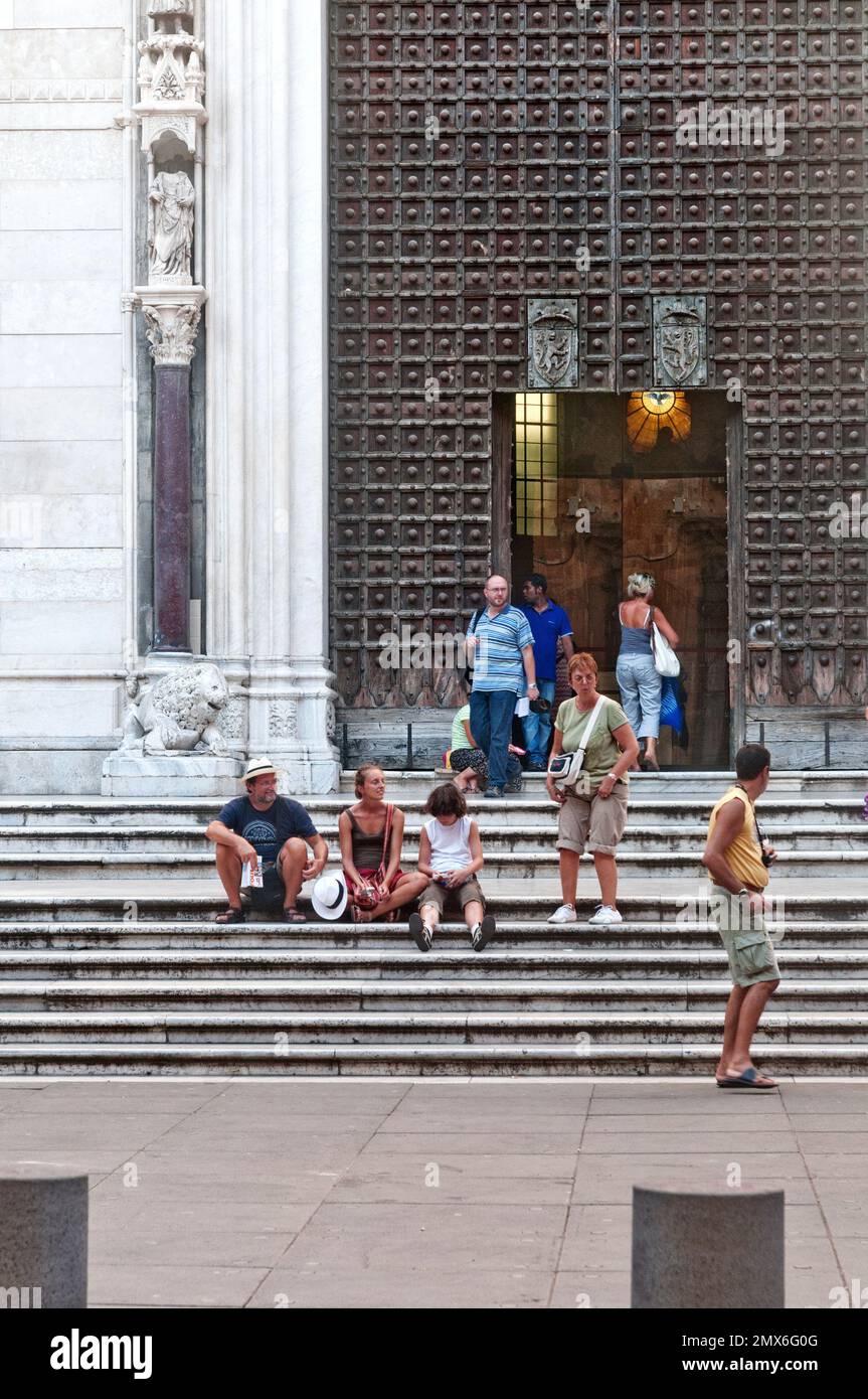 Tourists on steps outside the Cathedral of Naples, Italy Stock Photo ...