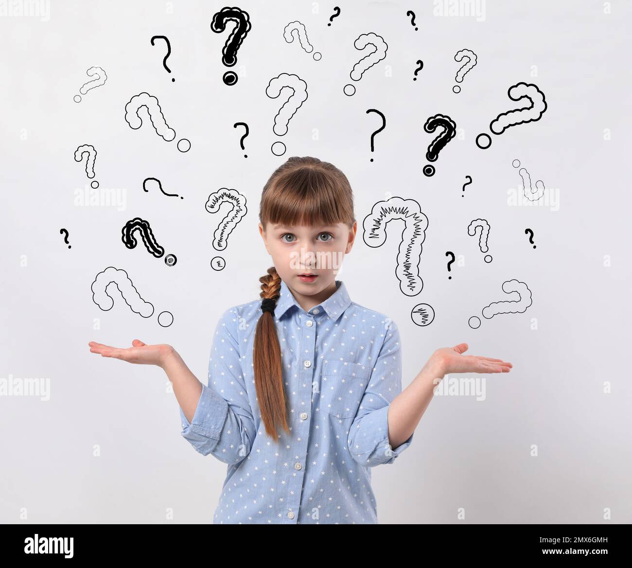 Emotional girl with drawings of question marks on white background ...