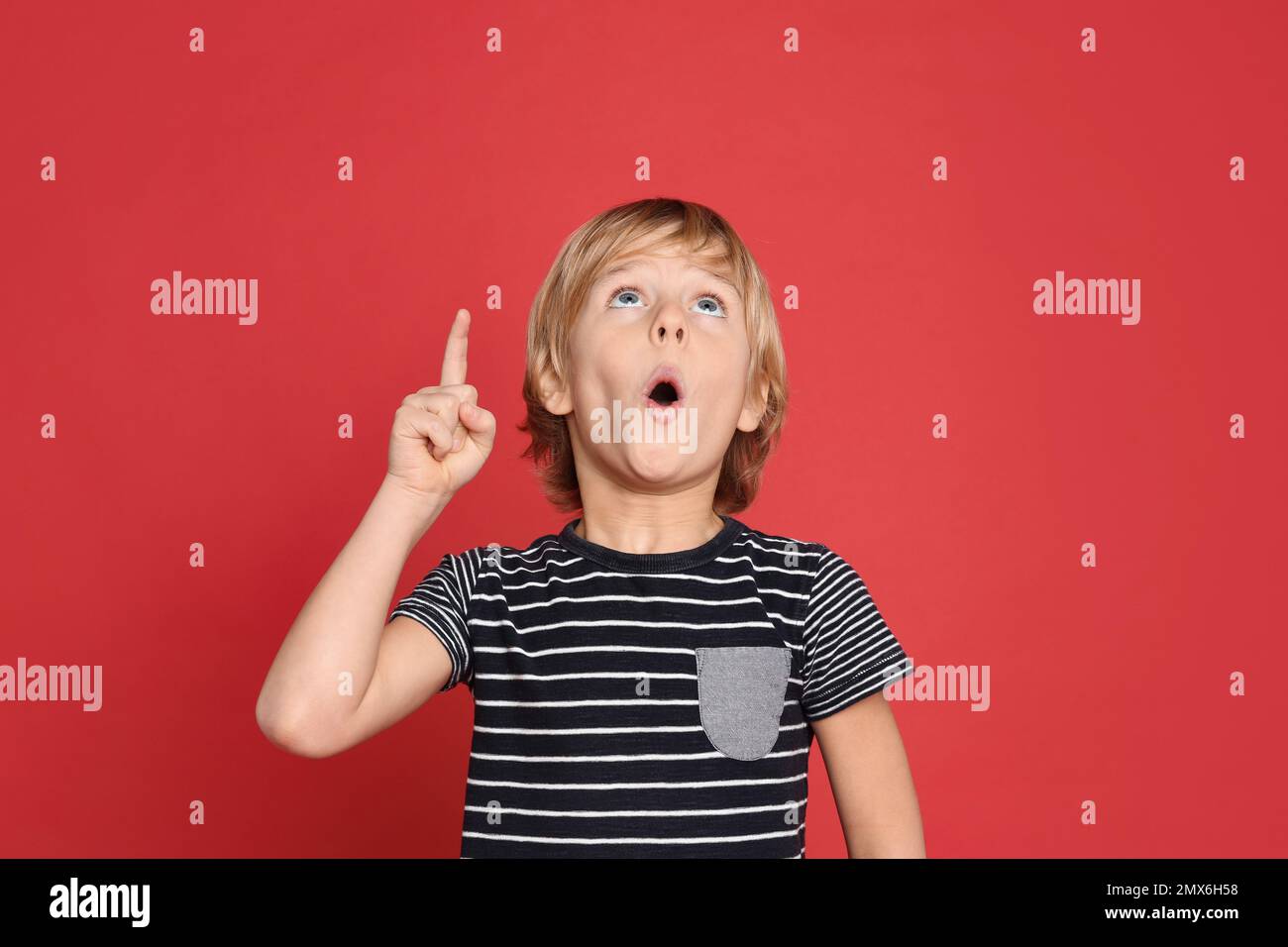 Portrait of cute little boy on red background Stock Photo - Alamy