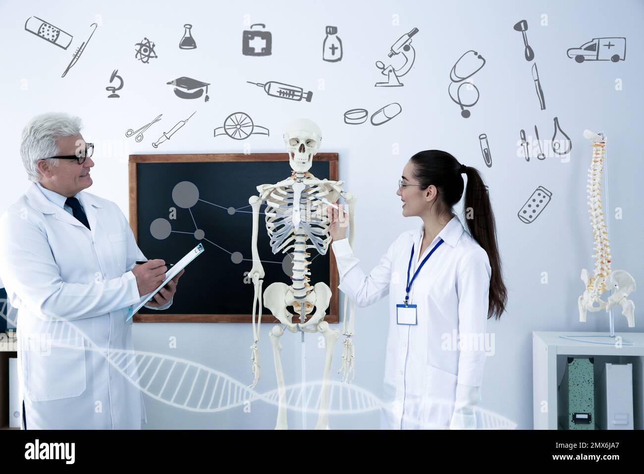 Medical student and professor studying human skeleton anatomy in ...