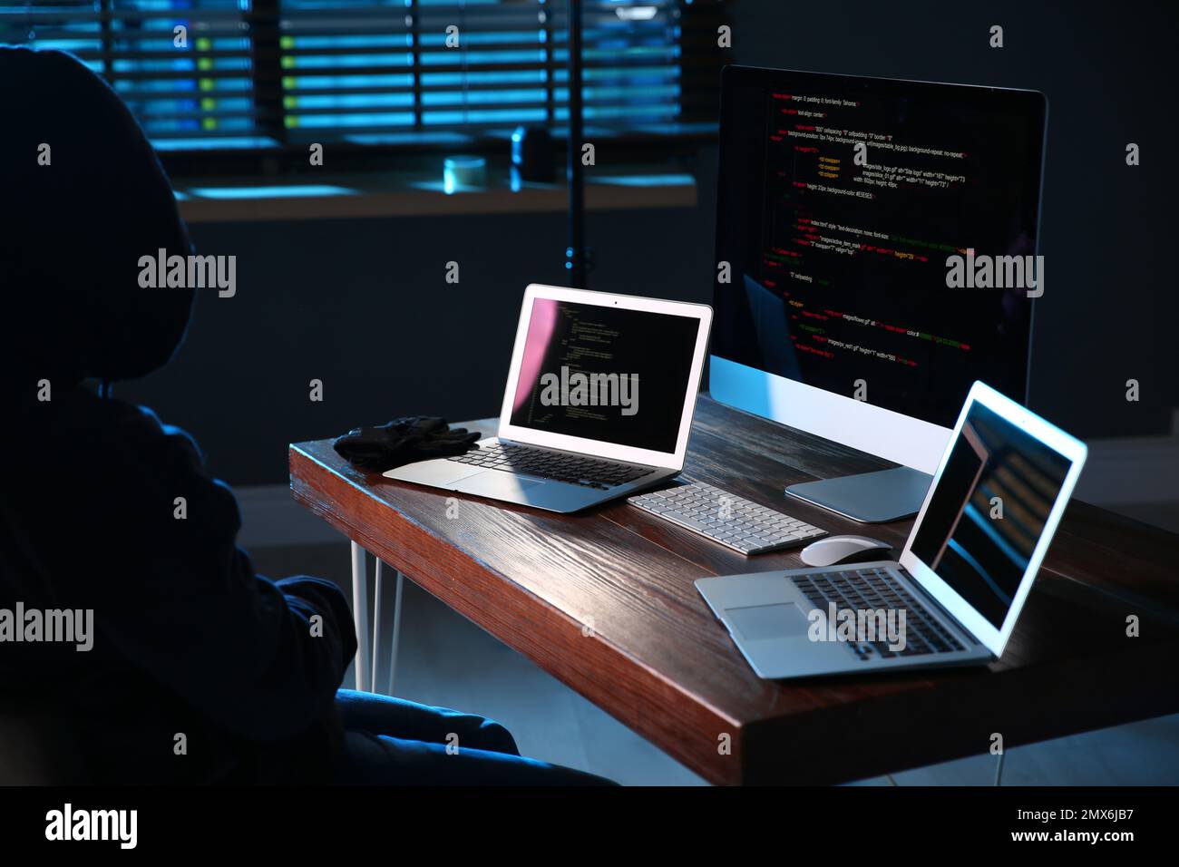 Hacker with computers in dark room. Cyber crime Stock Photo - Alamy