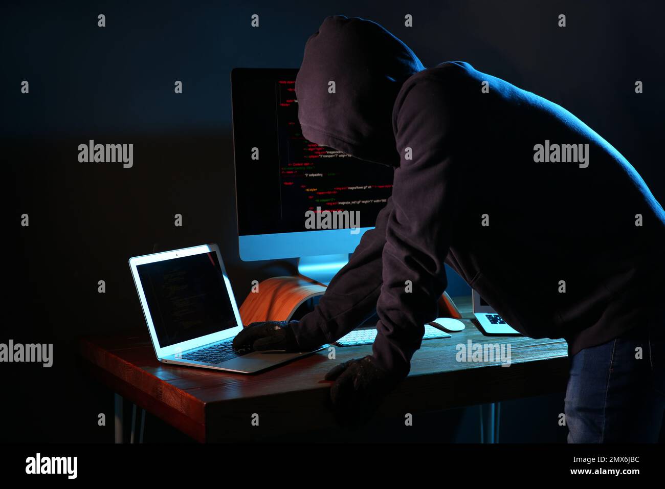 Hacker with computers in dark room. Cyber crime Stock Photo - Alamy