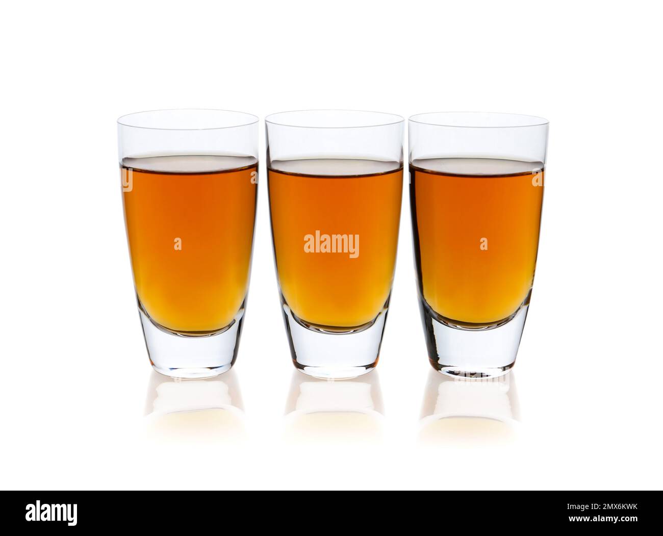 Three shots with drink isolated on white Stock Photo - Alamy